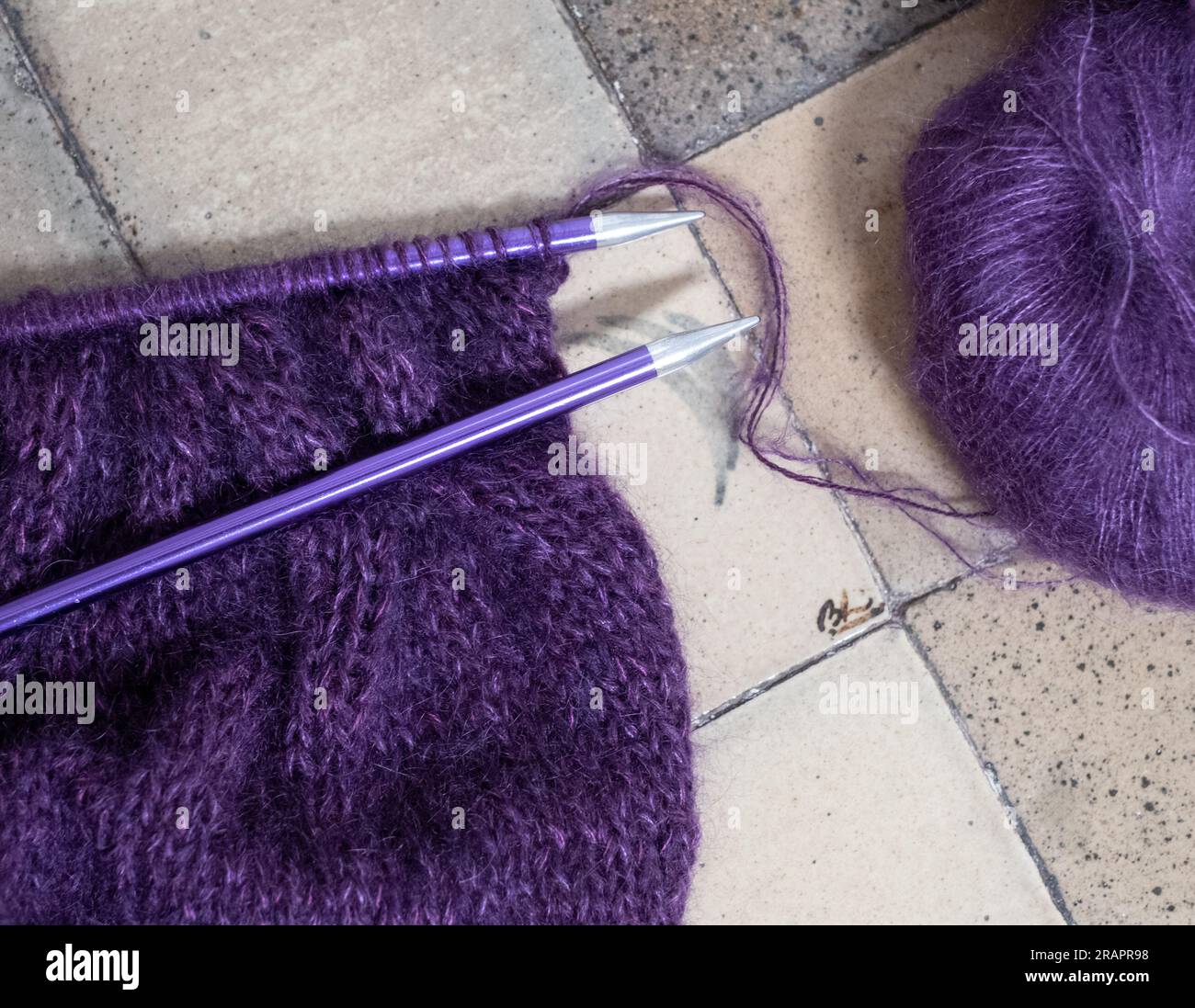 Close up of purple mohair and alpaca yarn hand knitted sweater with ...
