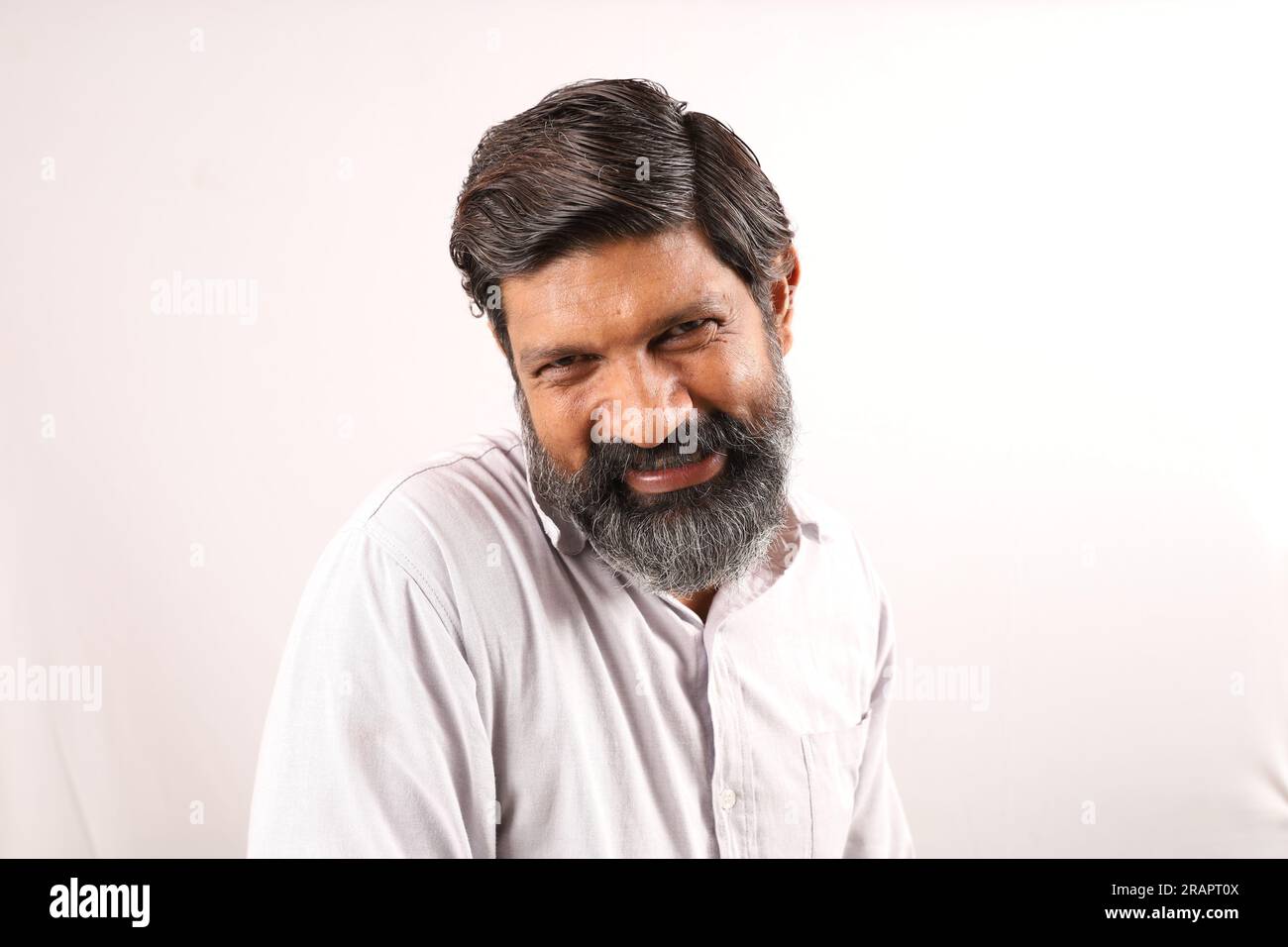 Portrait of an Indian bearded man wearing shirt. Funky expressions sad ...