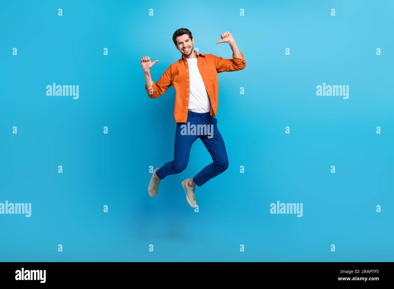 Full length portrait of crazy carefree active man jumping point fingers ...