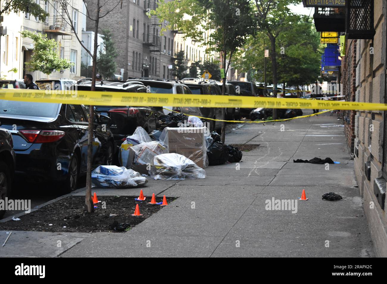 Evidence markers and police tape seen at the shooting incident. This ...
