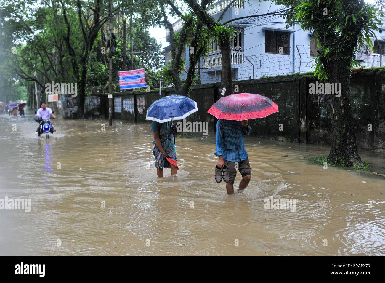People make their way during heavy rainfall. Incessant rains for the ...