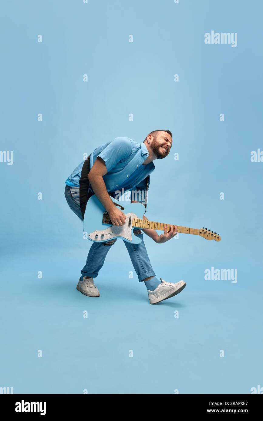 Artistic, expressive, talented man, musician in casual clothes playing ...