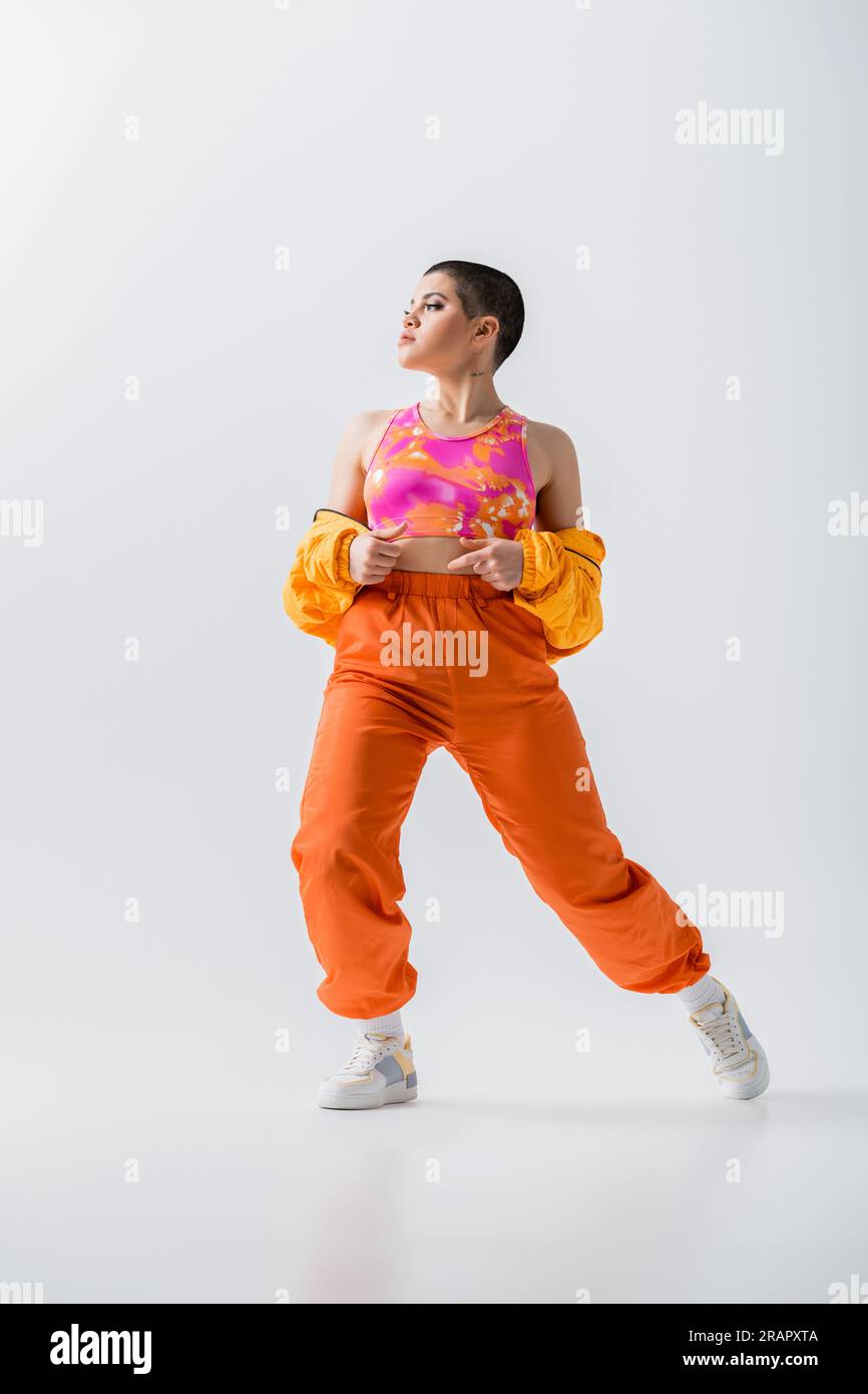 modern individual, warm clothing, fashionable young woman with short ...