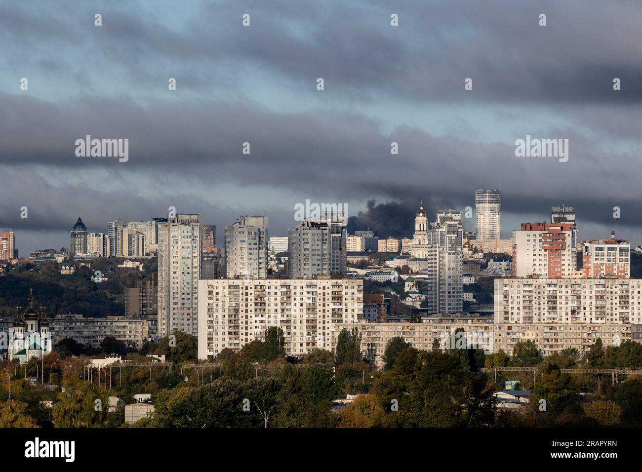 KYIV, UKRAINE - OCT 10 2022: Smoke rises over the city skyline after ...