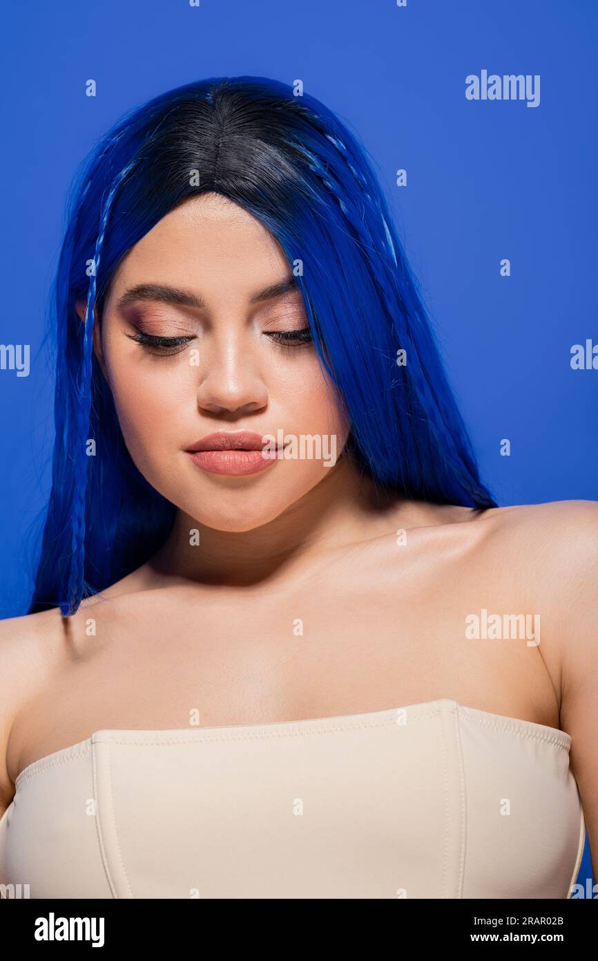 beauty industry, beautiful young woman with dyed hair posing on blue ...