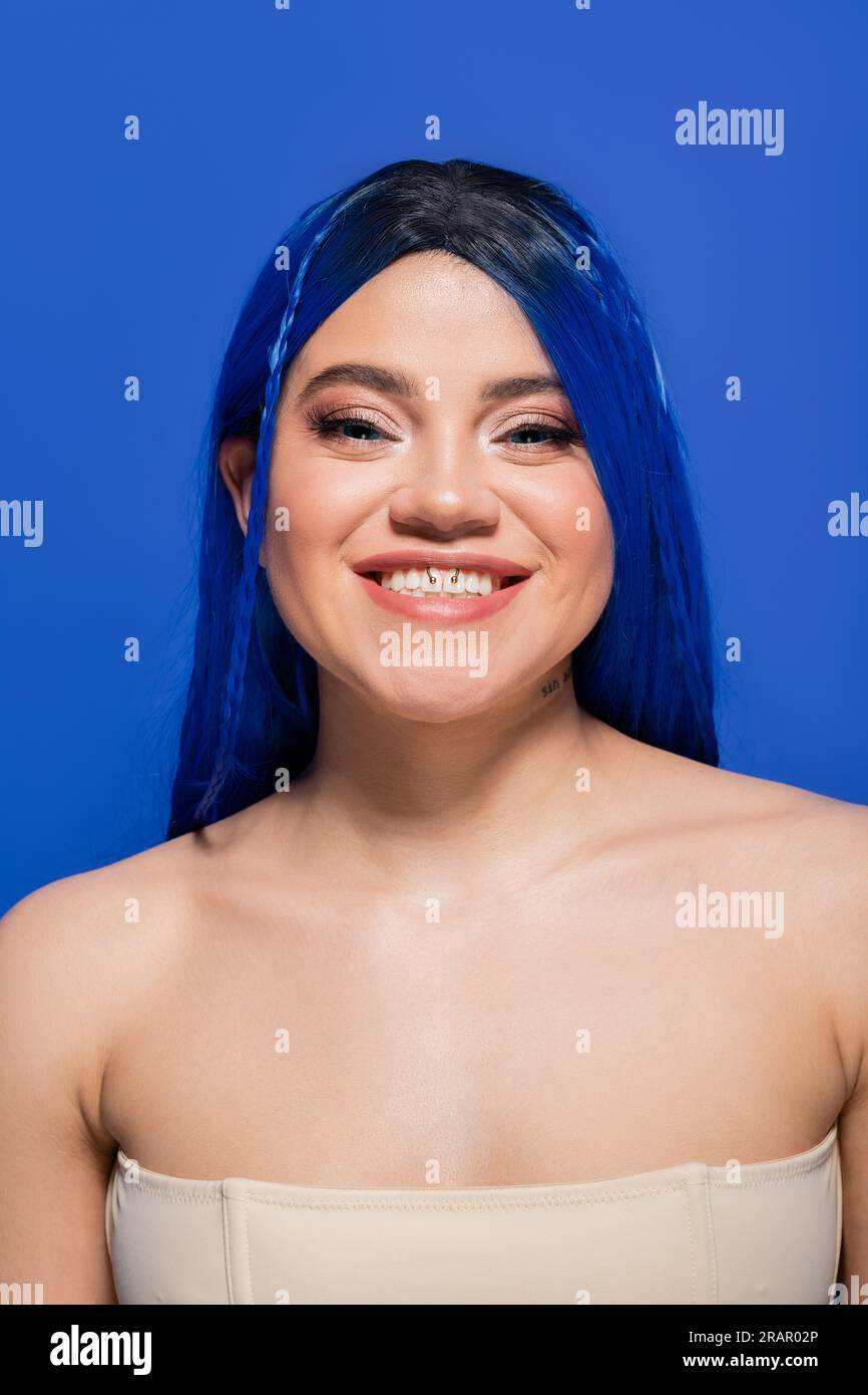 beauty trends, happy young woman with dyed hair posing on blue ...