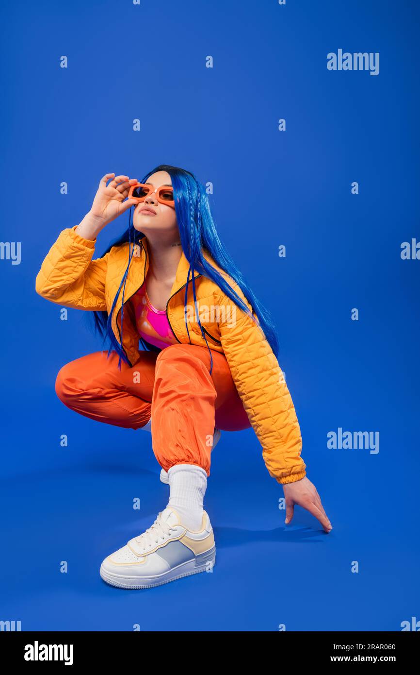 generation z, full length of pretty female model with blue hair and ...