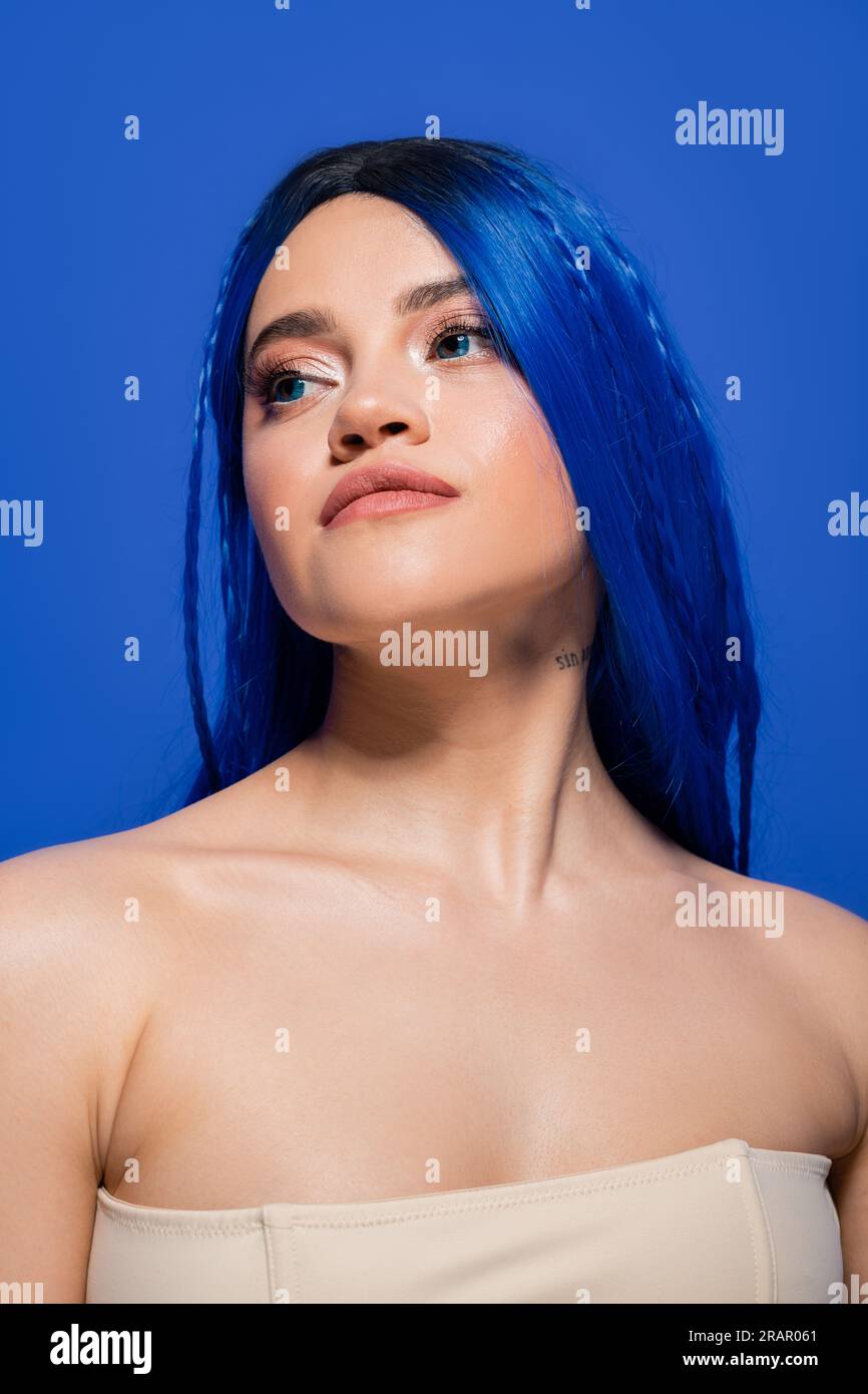 beauty trends, young woman with dyed hair posing on blue background ...