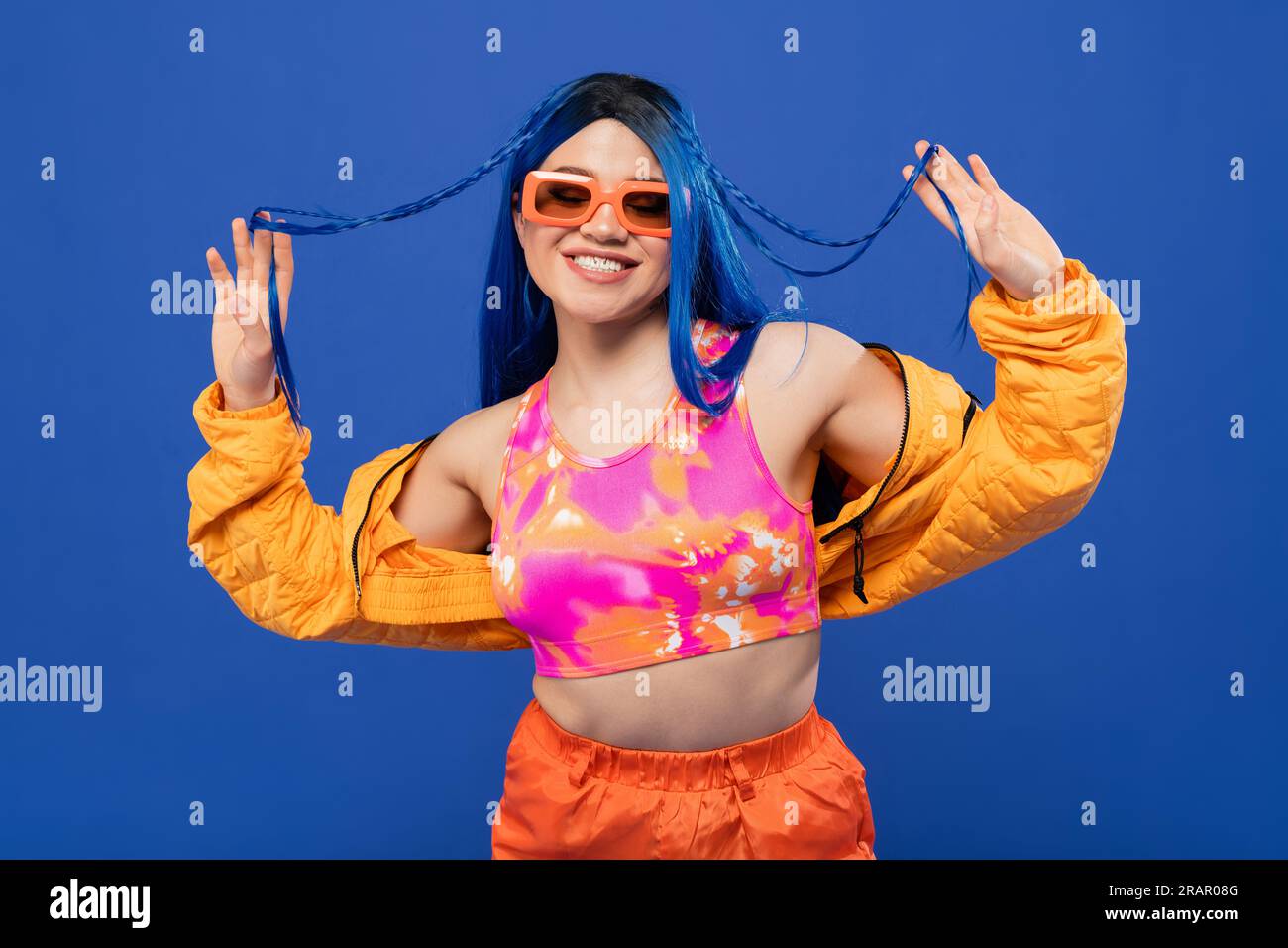 fashion statement, cheerful female model with blue hair and trendy ...