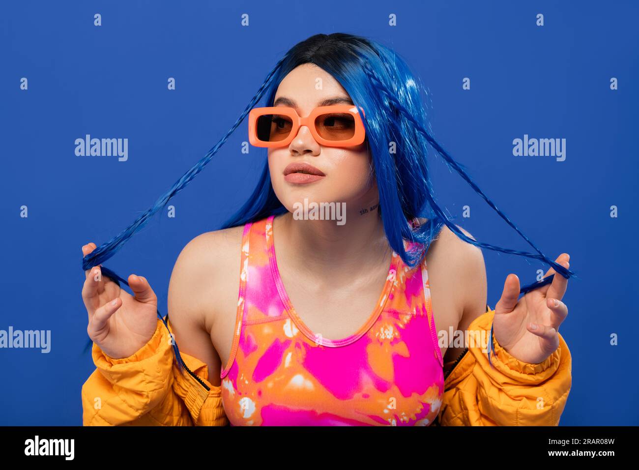 fashion statement, young female model with blue hair touching braids ...