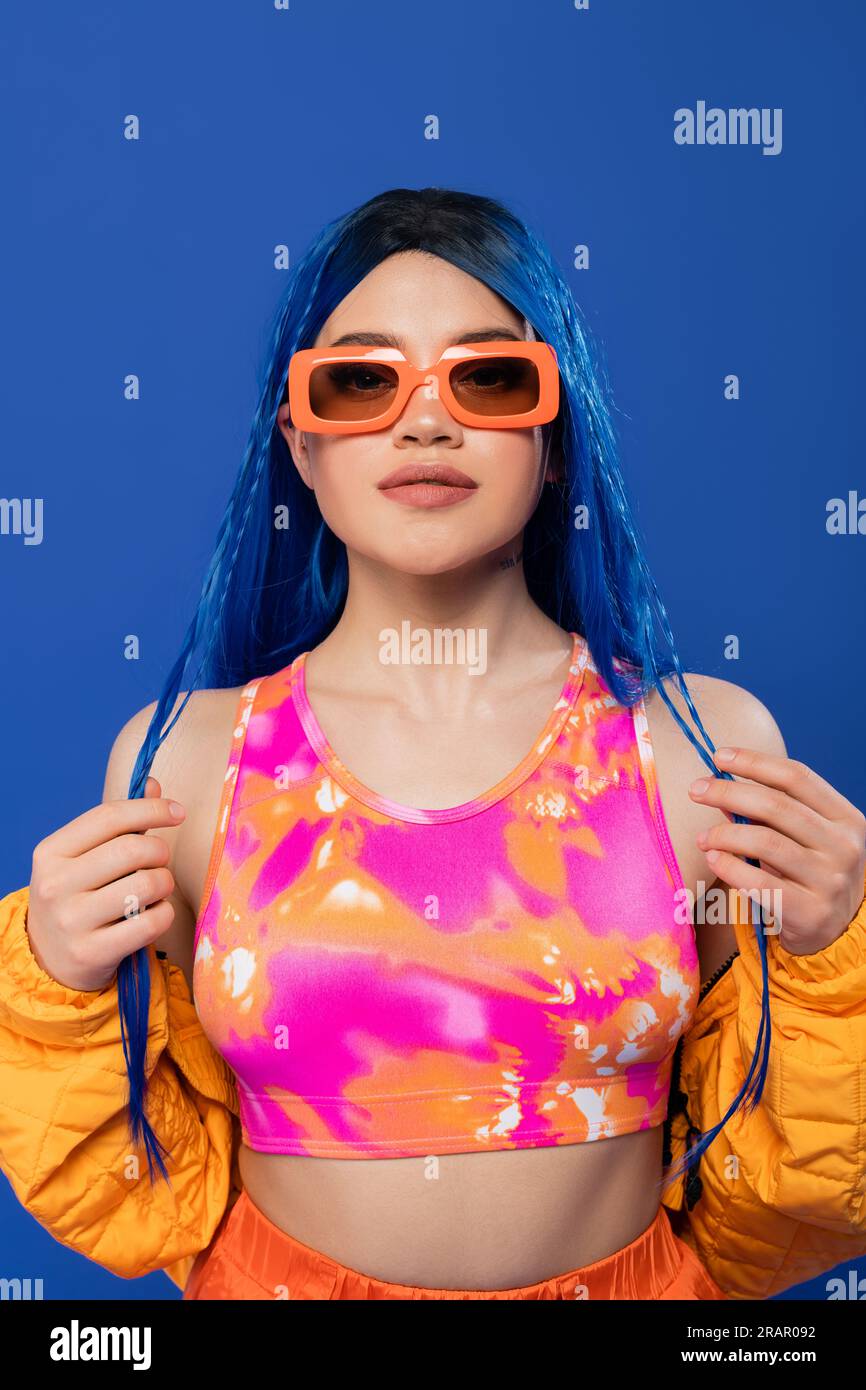 fashion statement, young female model with blue hair and braids posing ...