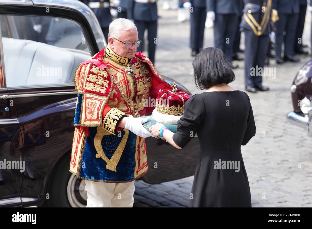 Lord Lyon King of Arms Joseph Morrow carrying the Crown, which forms ...