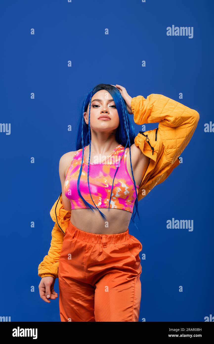 vibrant look, dyed hair, female model with blue hair posing in puffer ...
