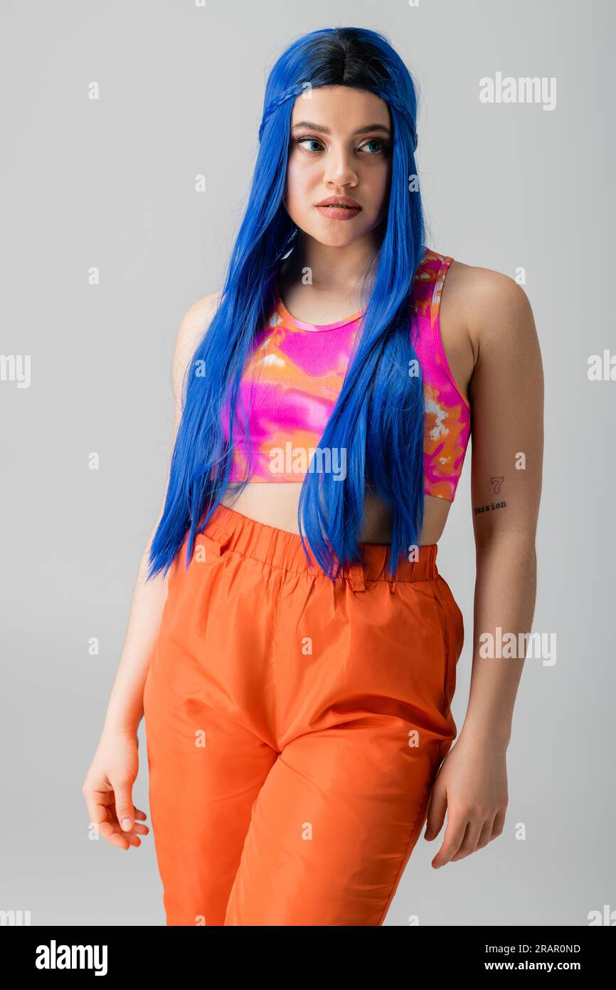 fashion forward, youthful energy, tattooed young woman with blue hair ...