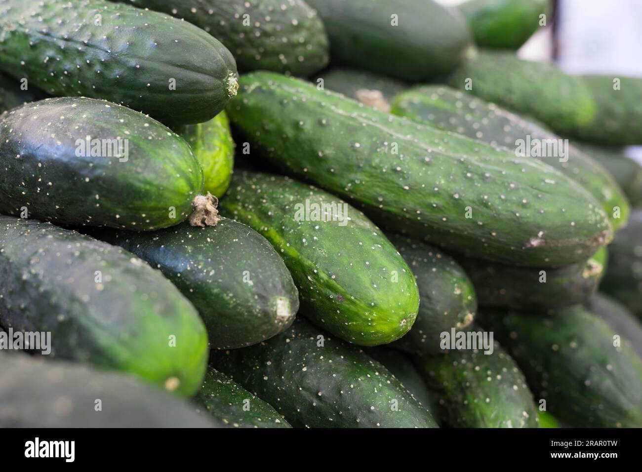 cucumbers on market counter in wicker basket Stock Photo - Alamy