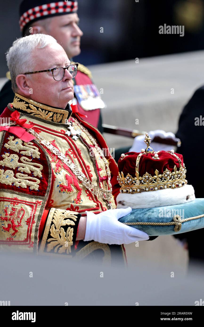 Lord Lyon King of Arms Joseph Morrow carrying the Crown, which forms ...