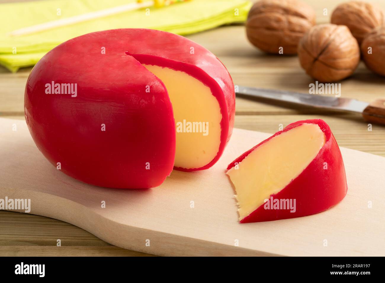 Traditional Austrian red waxed Ratsherrenkase and a piece on a cutting ...