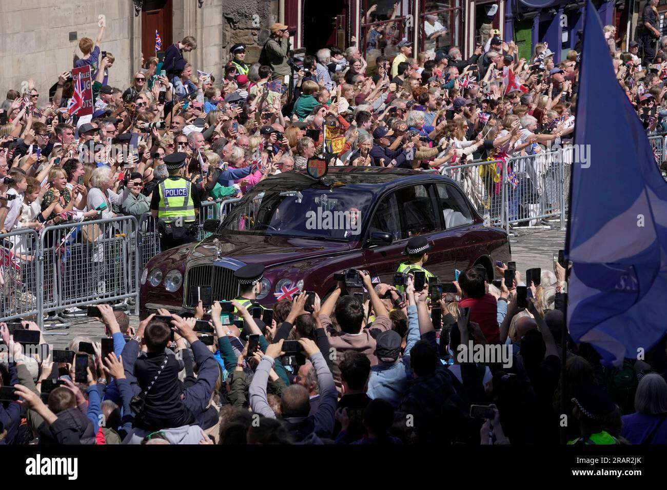 King Charles III and Queen Camilla proceed along the Royal Mile in ...