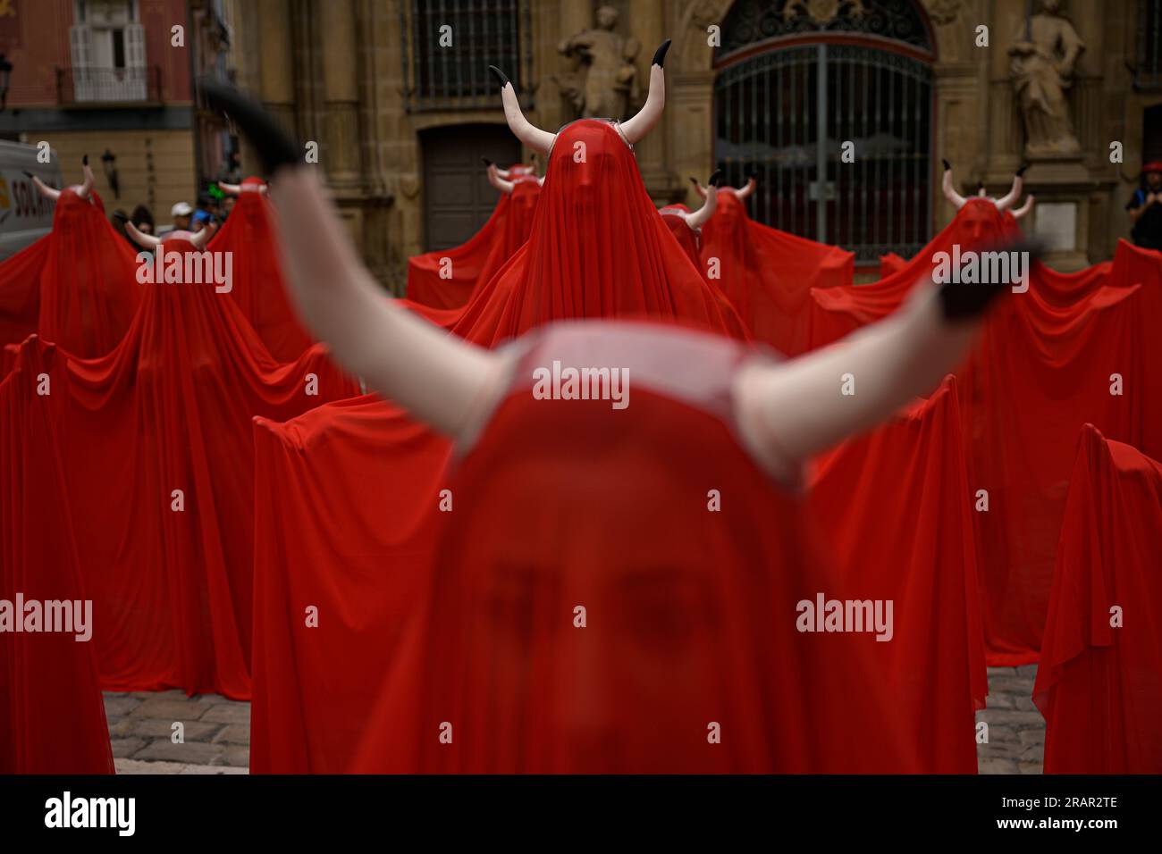 People covered with San Fermin's red color protest against animal ...