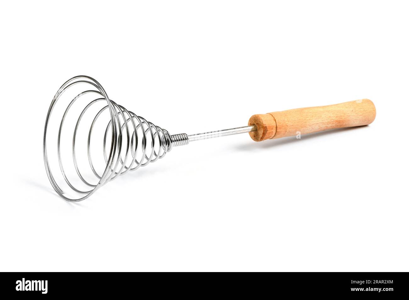 Close-up of old retro whisk kitchen tool on white background. Side view ...