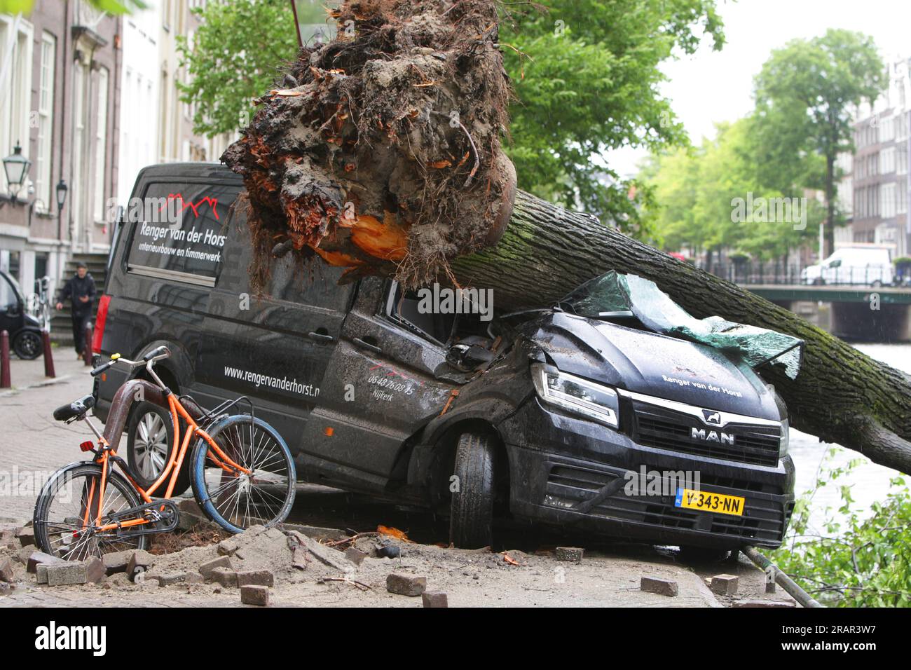 Amsterdam, Netherlands. 05th July, 2023. A fallen tree over on the van ...