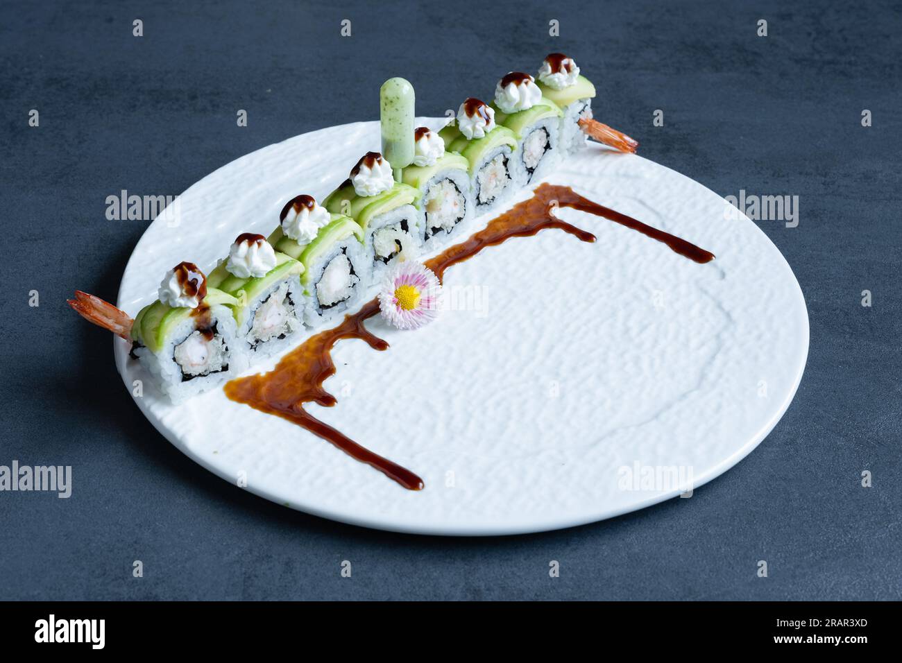 Sushi restaurant, Uramaki angel Roll served on white color round plate ...