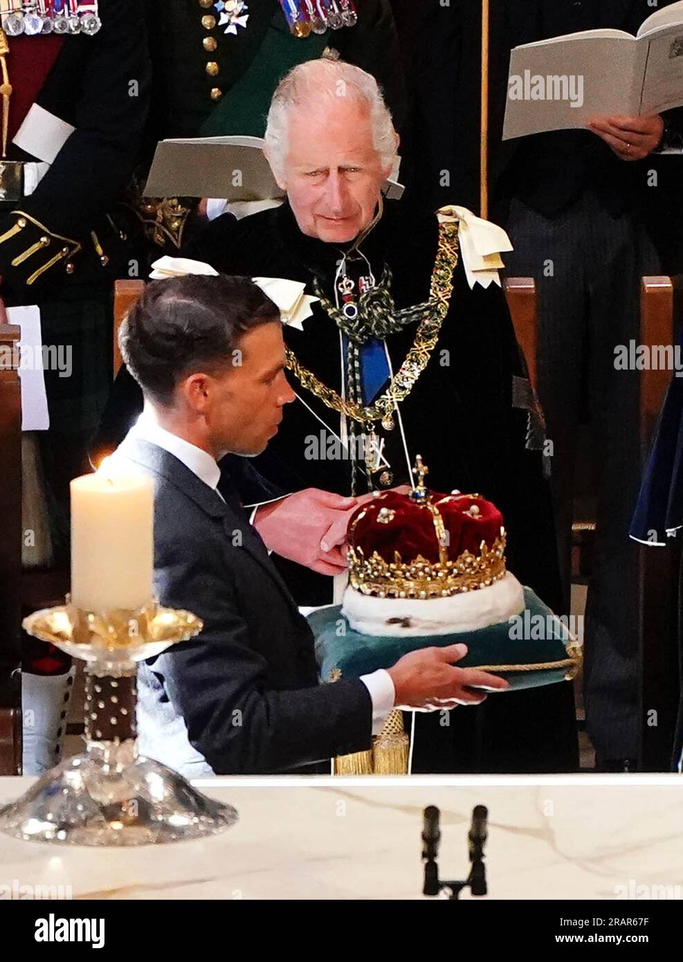 King Charles III looks at the Crown of Scotland during the National ...