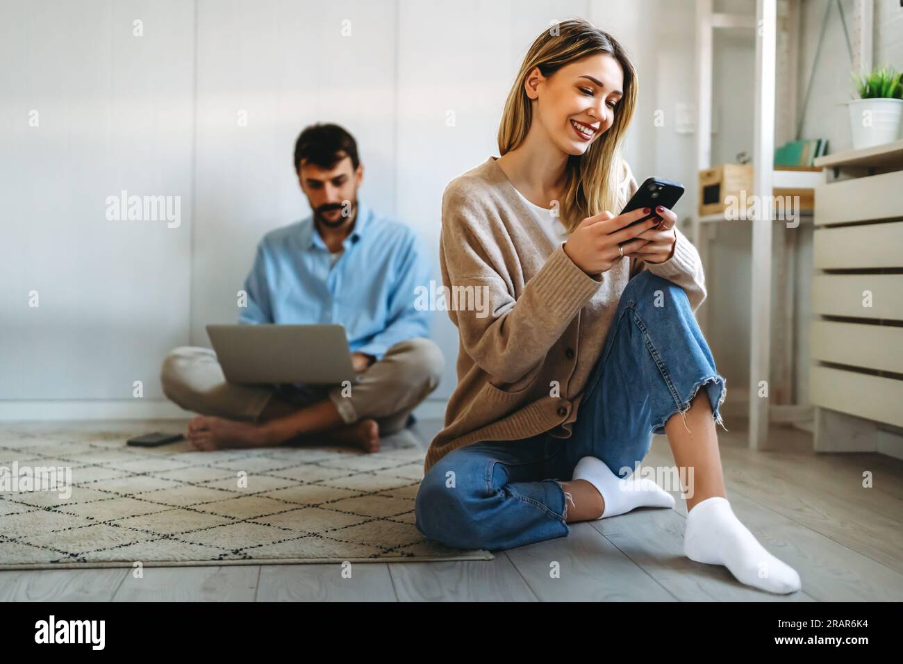 Freelancing couple working together at digital devices in home office ...