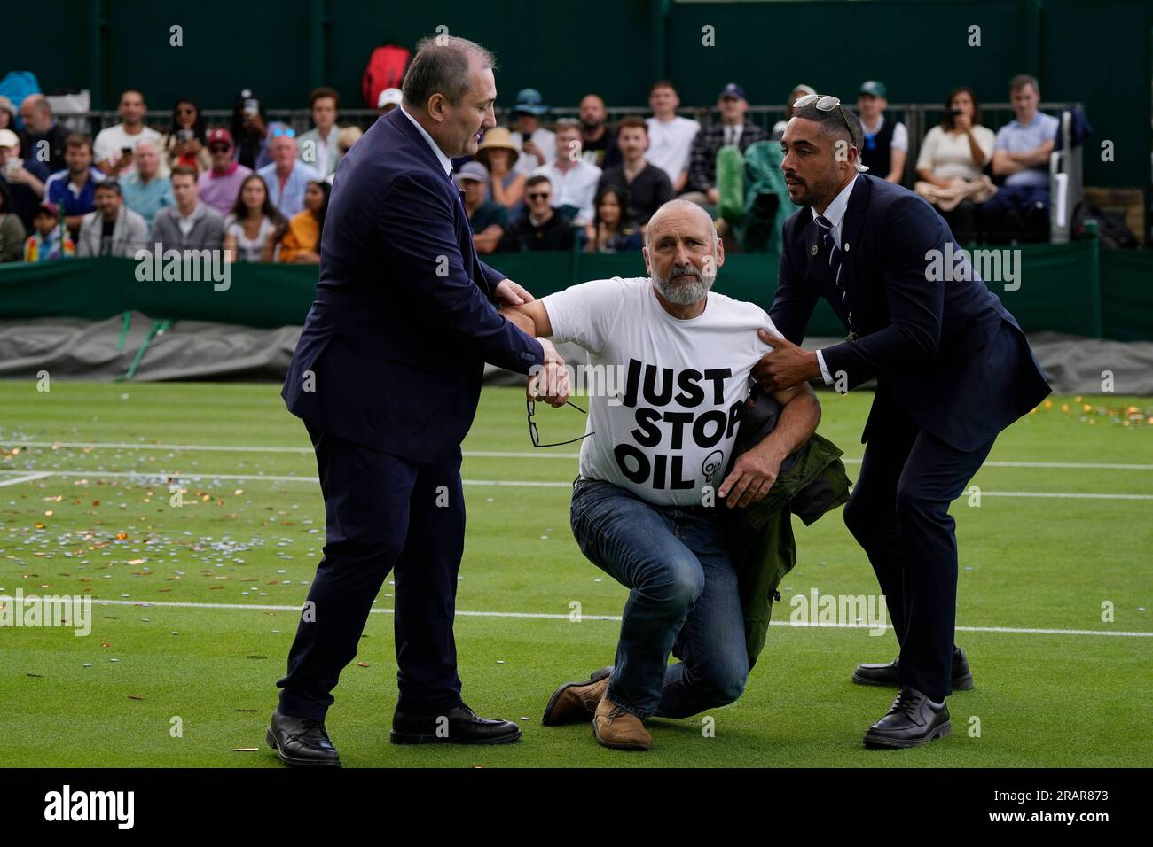 A Just Stop Oil protester is removed from Court 18 on day three of the ...