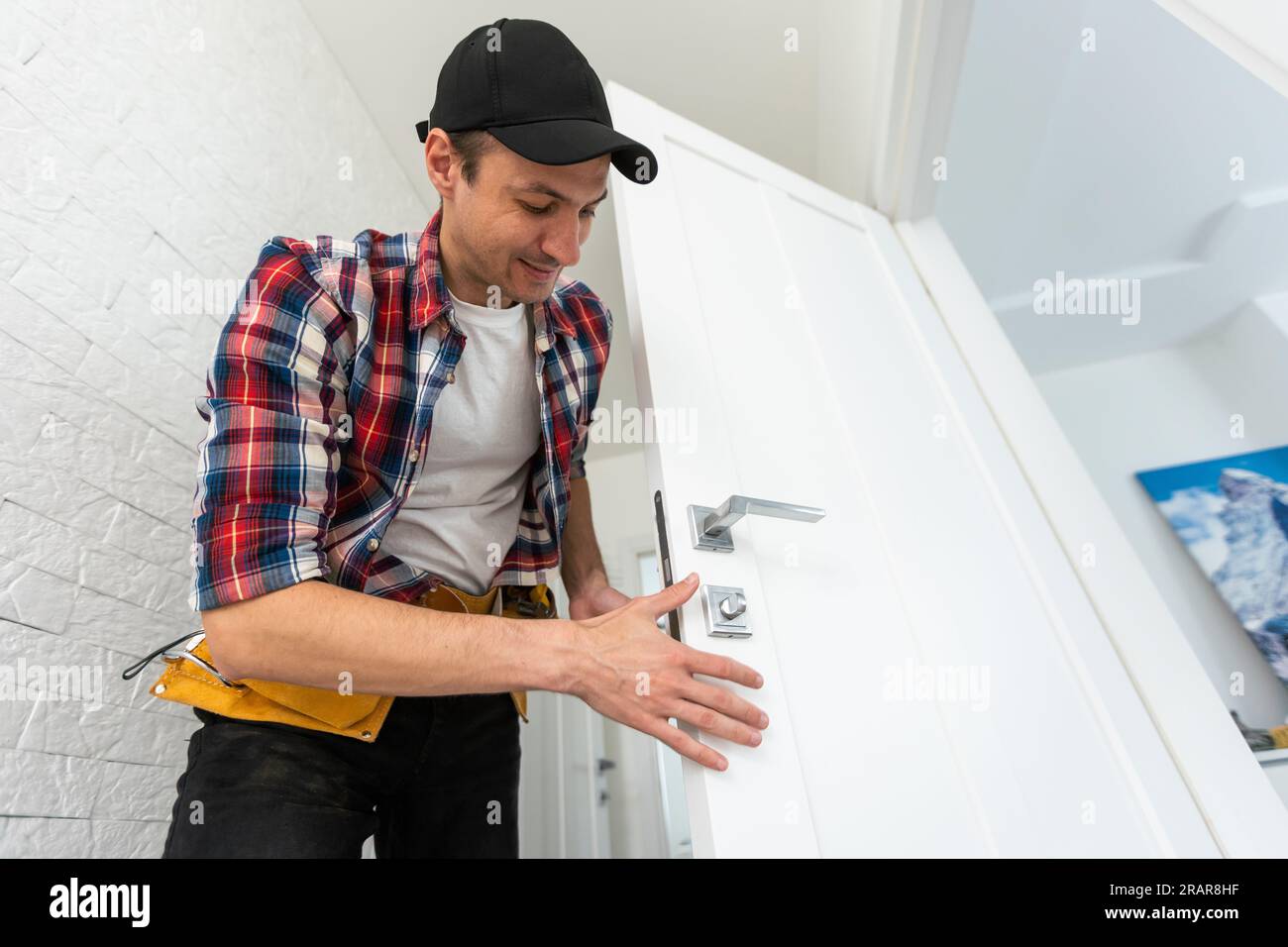 Man removing lock from door Stock Photo - Alamy