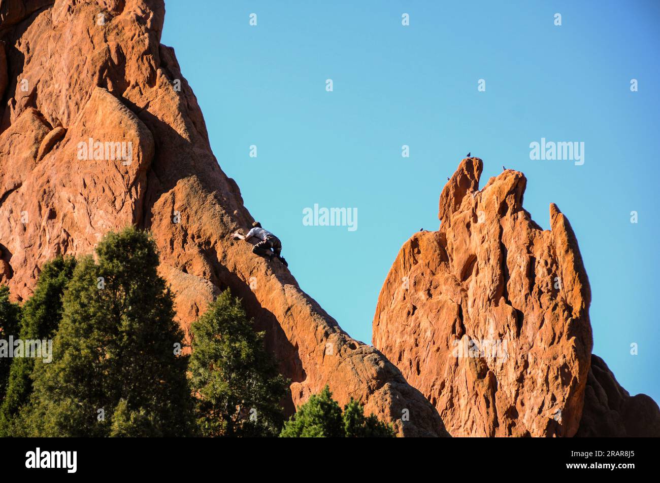 Male clinging on the rock hi-res stock photography and images - Alamy