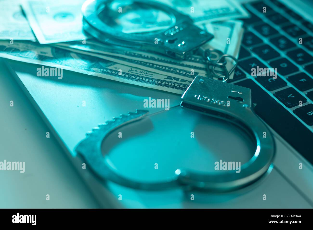 Pair of handcuffs closeup on dollar banknotes background. Corruption ...