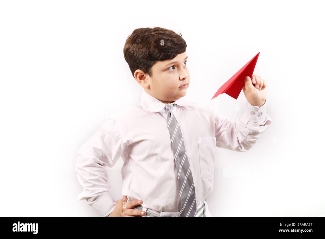 Happy Indian school kid playing with paper airplane and dreaming about ...