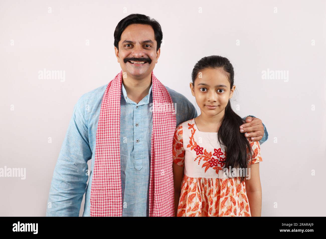 happy Rural Indian farmer standing with his daughter hands on the ...