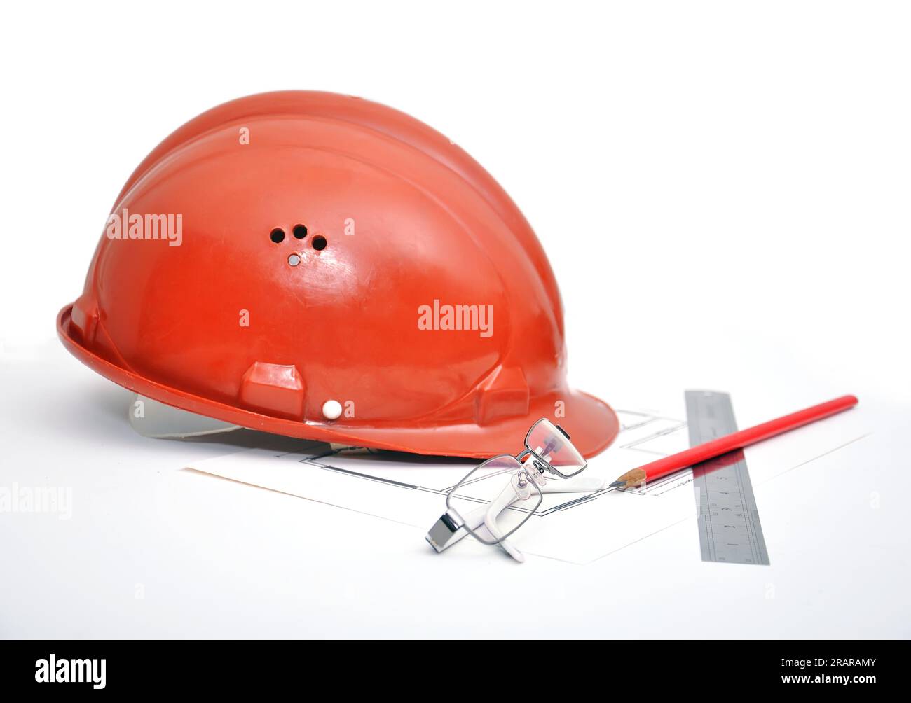 hard hat with blueprints and tools on table Stock Photo - Alamy