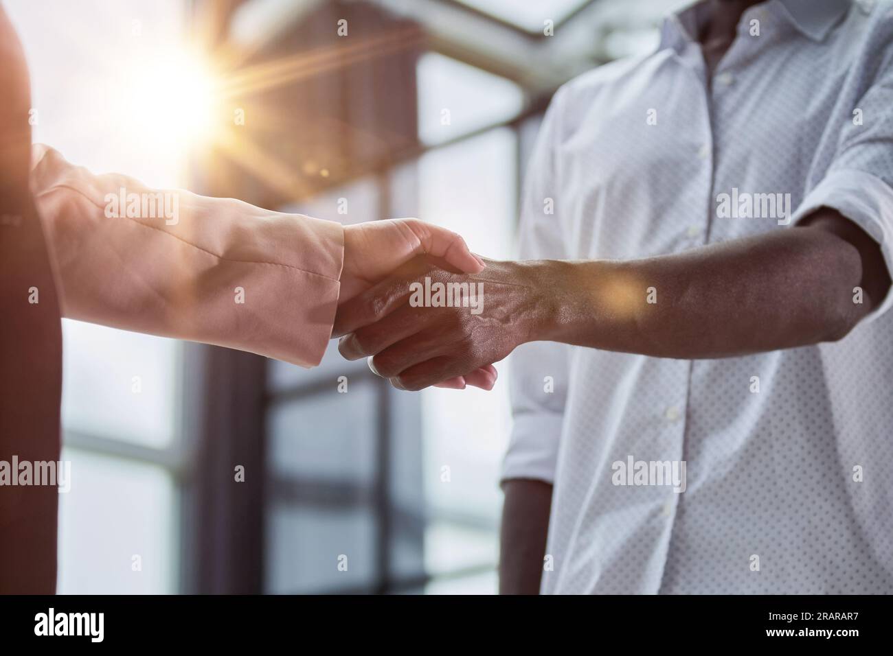 Manager greeting new employee and smiling in office Stock Photo - Alamy
