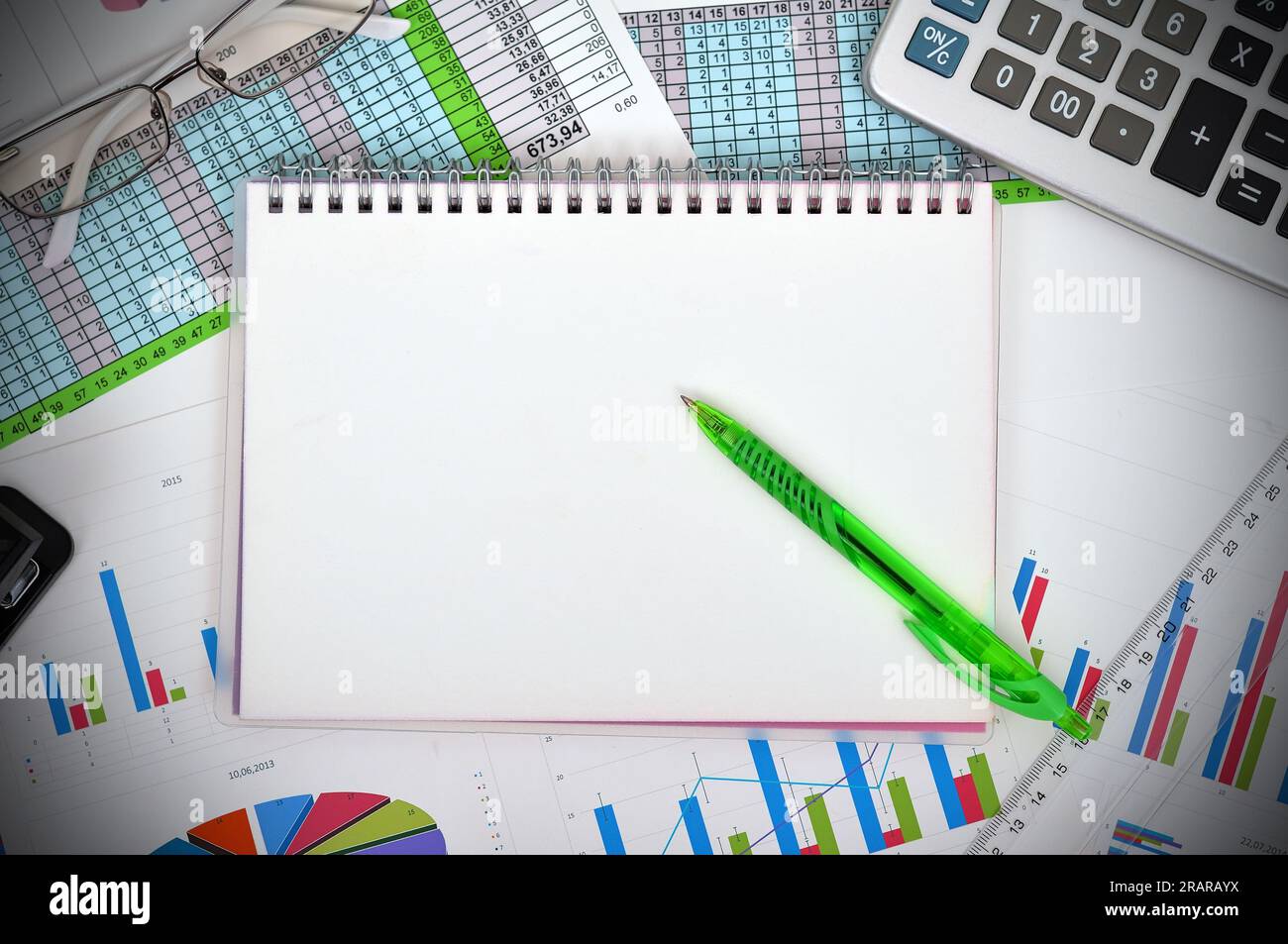 blank notebook and financial charts Stock Photo - Alamy