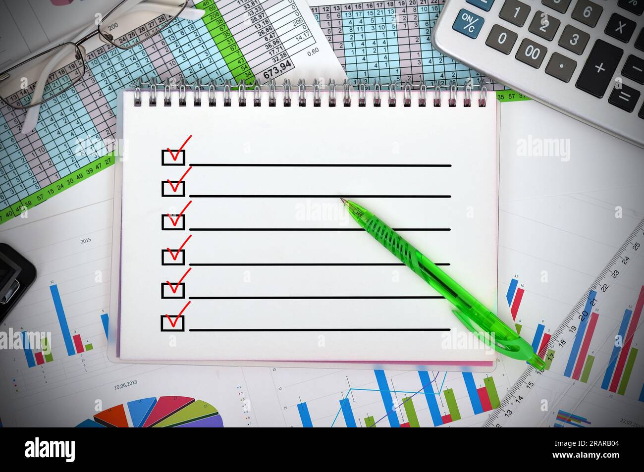 notebook with drawing check box and financial charts Stock Photo - Alamy