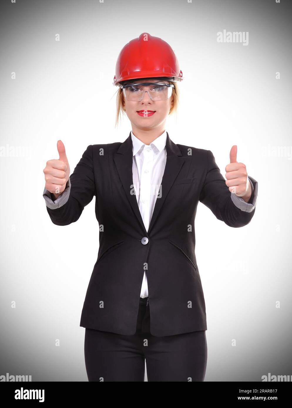 Woman engineer showing thumb up symbol on white background Stock Photo ...