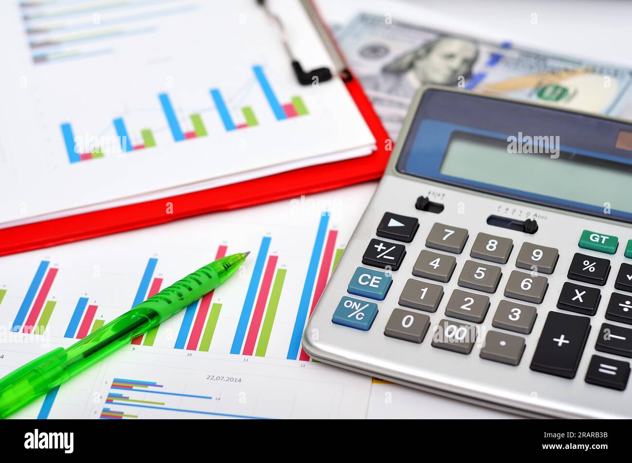 clipboard with charts, pen and calculator on table Stock Photo - Alamy