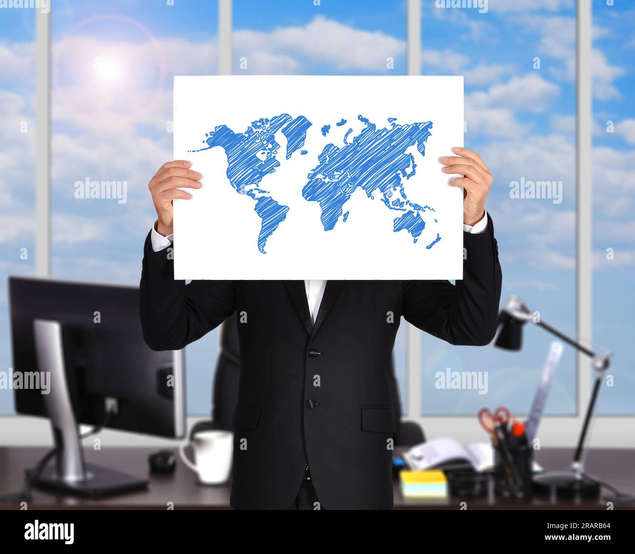 Businessman holding poster with a world map Stock Photo - Alamy