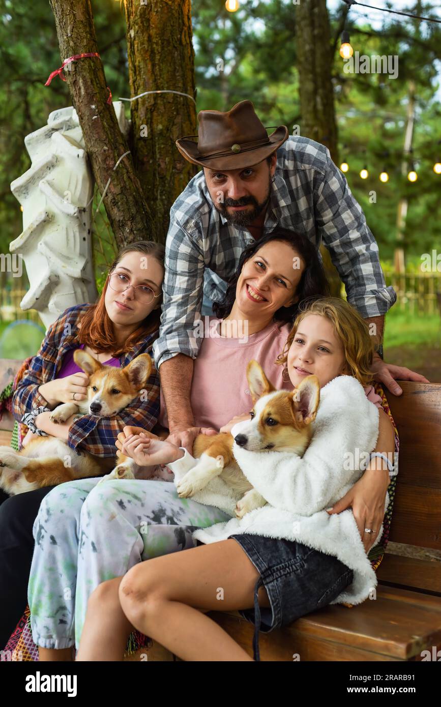 Family members father, mother and two daughters with corgi dogs in the ...
