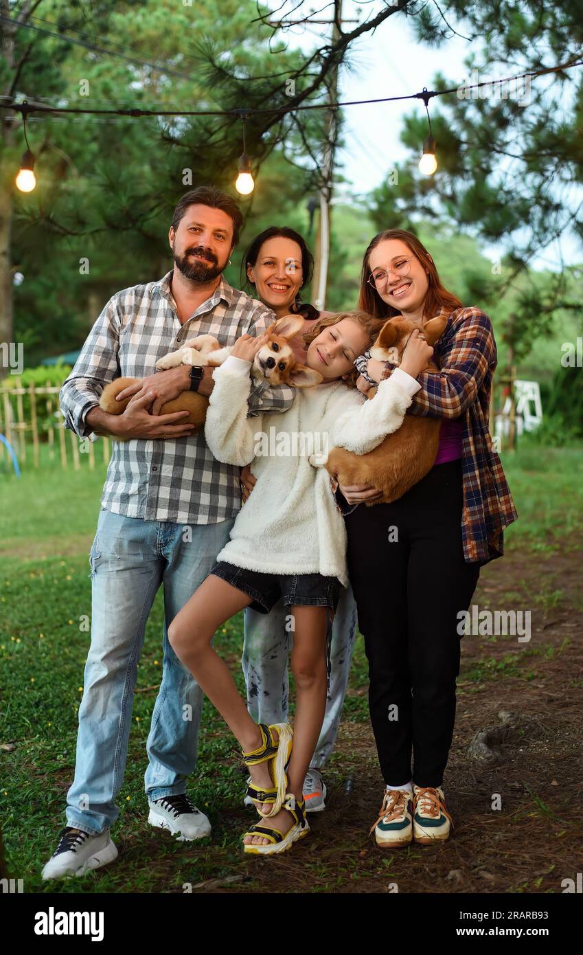 Family members father, mother and two daughters with corgi dogs in the ...