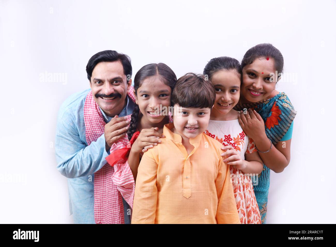 Indian rural happy villager family standing together on a white ...