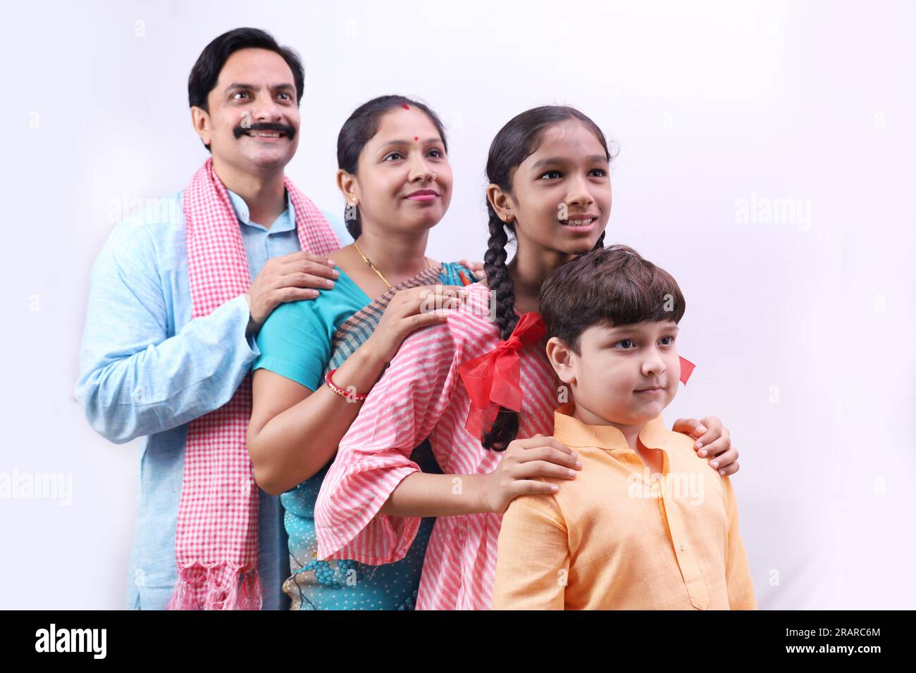 Indian rural happy villager family standing together on a white ...