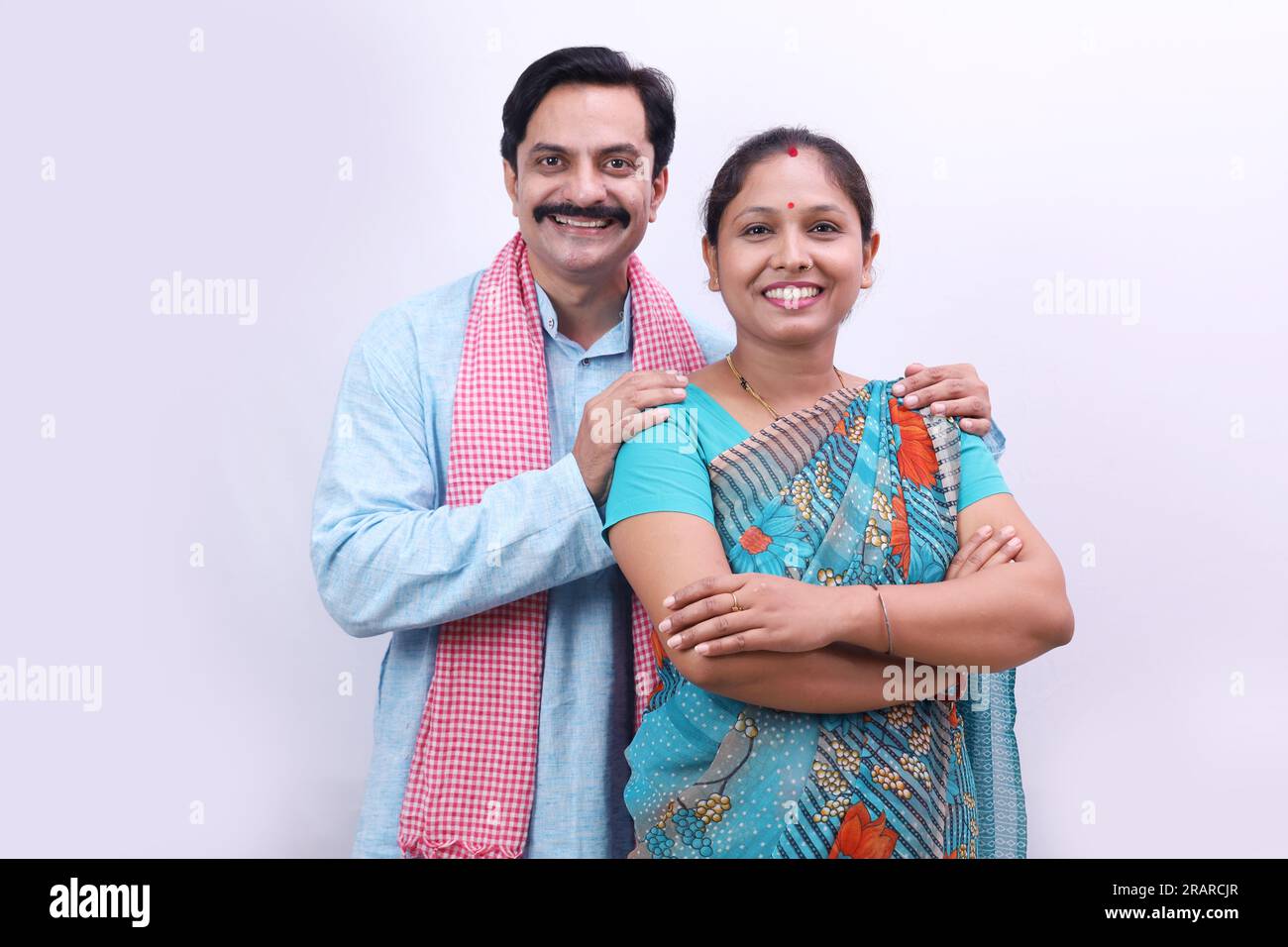 Indian rural happy villager couple standing together on a white ...