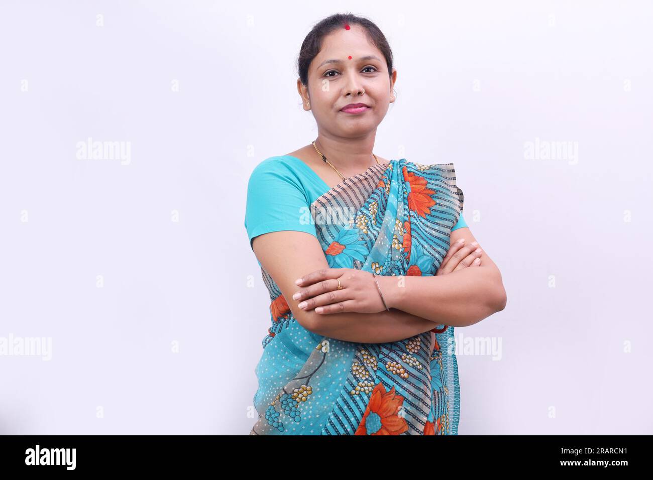 Indian rural happy villager woman standing in saree on a white ...