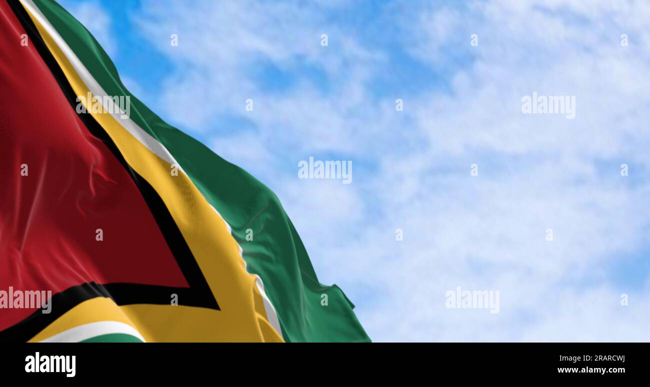 Close-up view of the Guyana national flag waving in the wind. Green ...