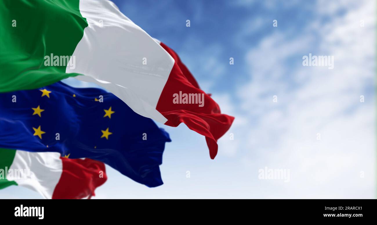 Flags of Italy and the European Union waving in the wind on a clear day ...