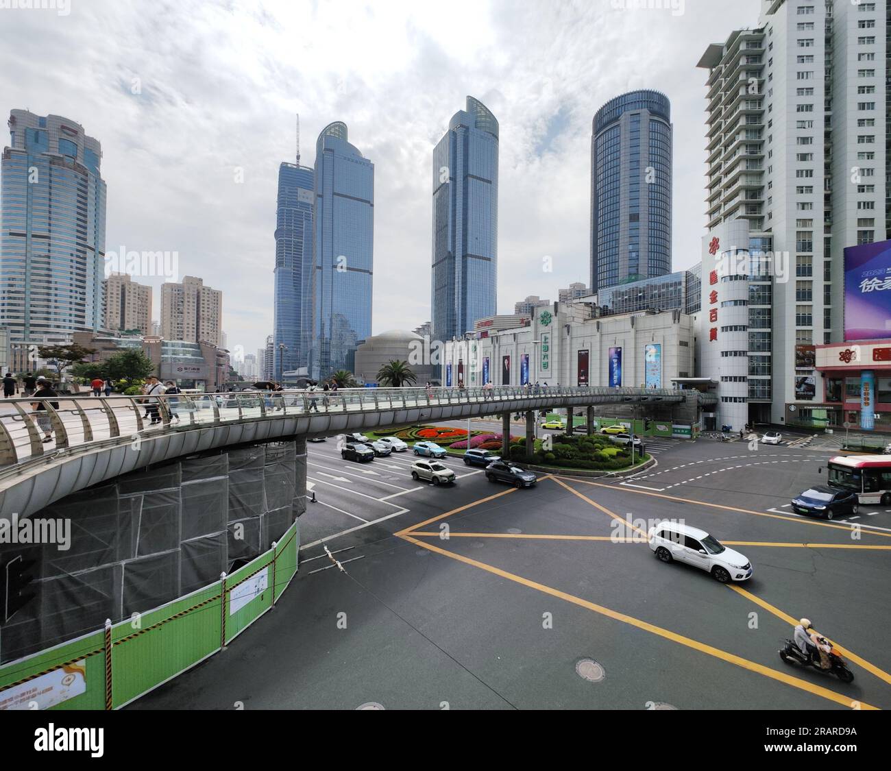 Pedestrian overpass bridge at Xujiahui area with shopping mall ...